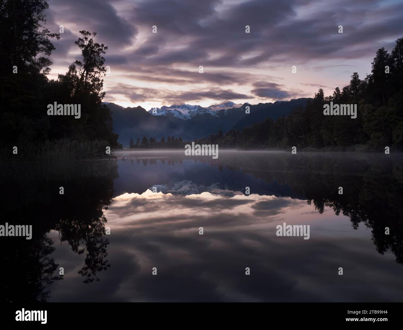 Sunrise at Lake Matheson, with Mount Tasman and Mount Cook in the ...