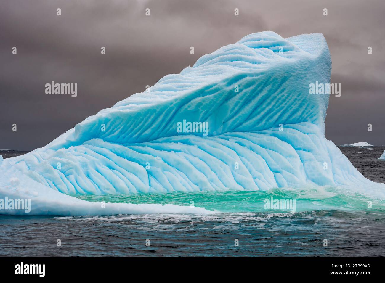 Iceberg floating against stormy sky; Antarctica Stock Photo - Alamy