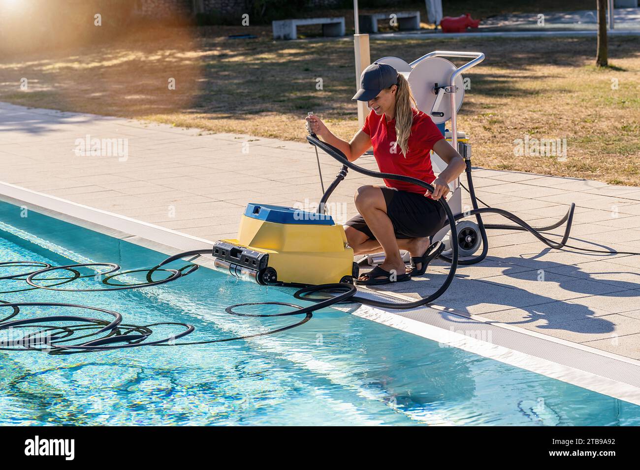 Woman cleaning swimming pool hi-res stock photography and images - Alamy