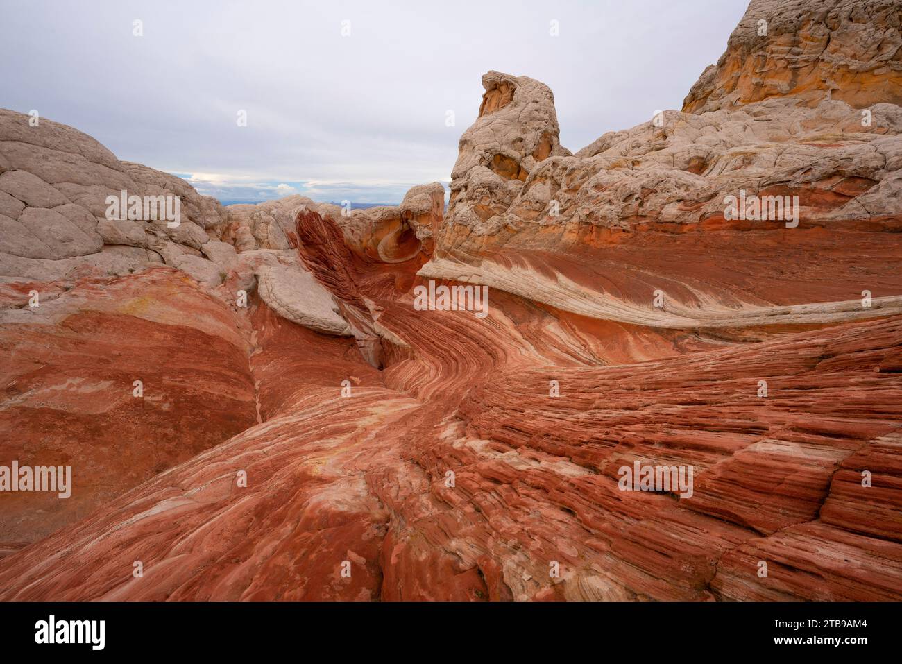 Scenic view of swirling patterns and hilly, rock formations under a ...