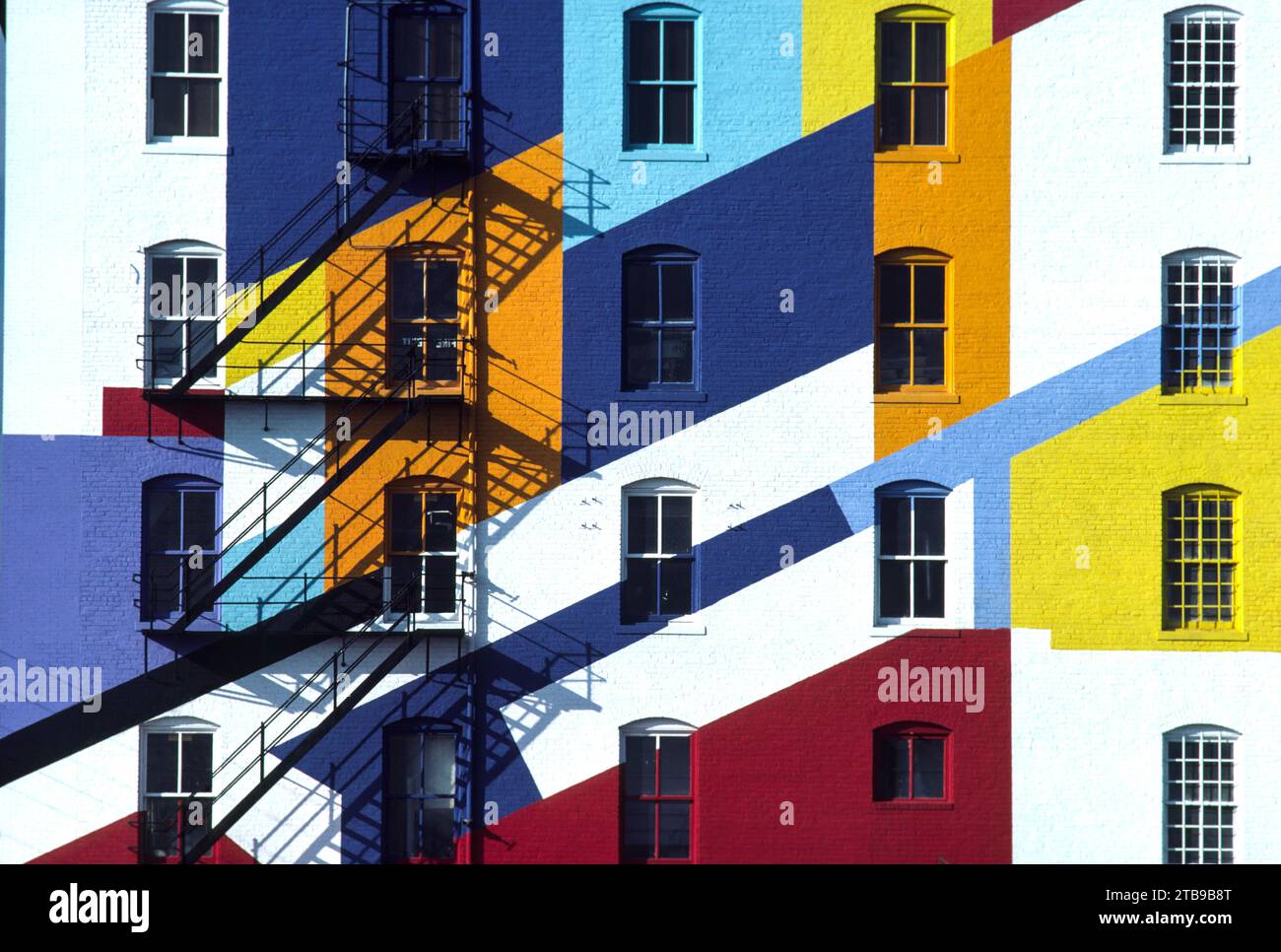 Fire escape on a colorfully painted building; New York City, New York ...