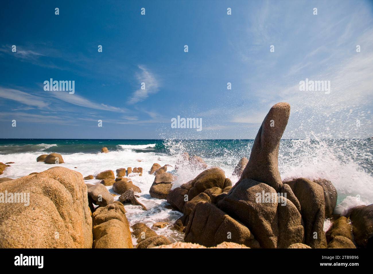 Blue water splashing against rocks on the beach on the Cote d'Azure ...
