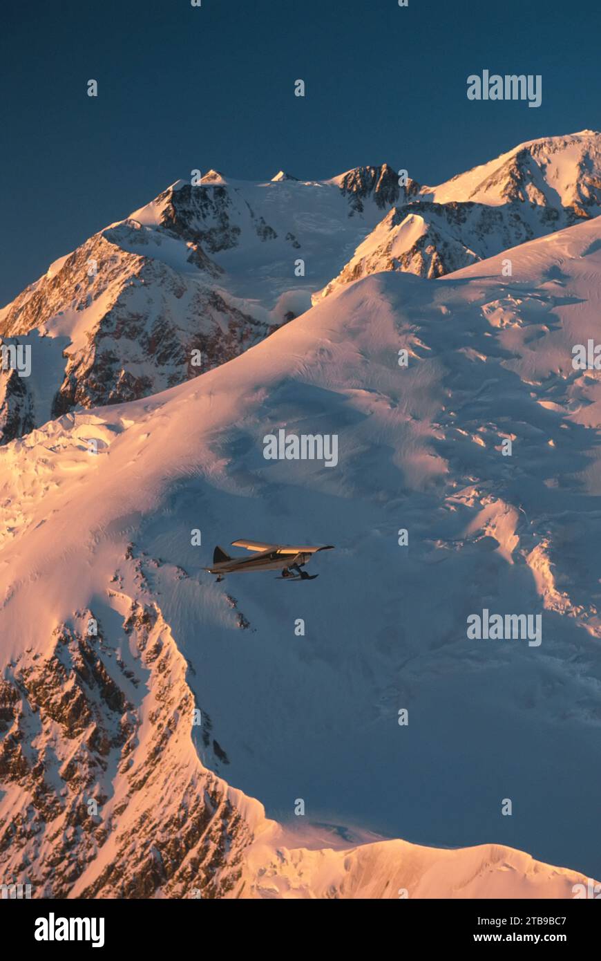 Ski plane flies past Mount Denali in Denali National Park and Preserve ...