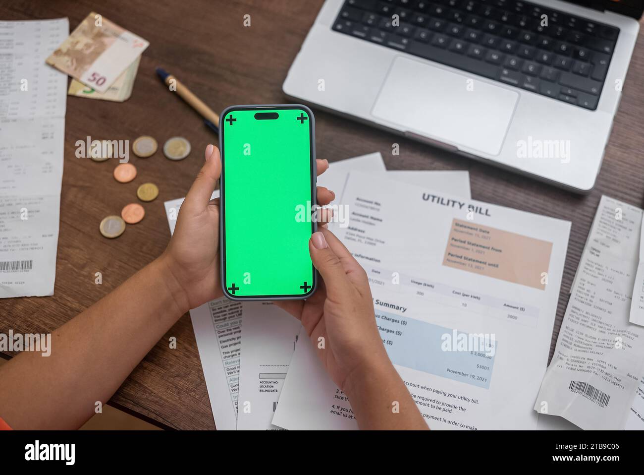 woman hand holds mobile phone with chroma key screen, amidst utility ...