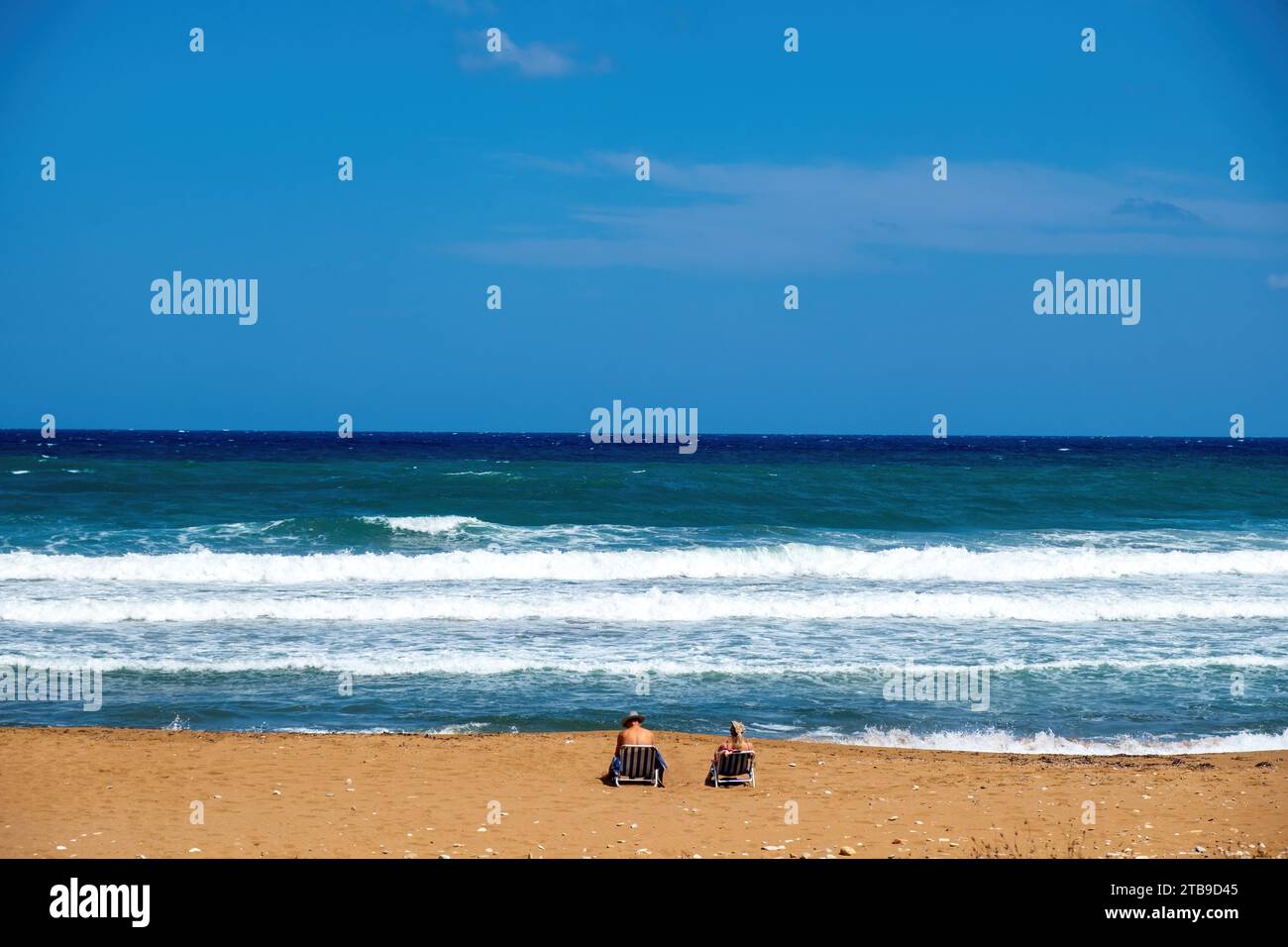Greek sandy beach. Ripple dark sea water, splashing white foam, blue ...