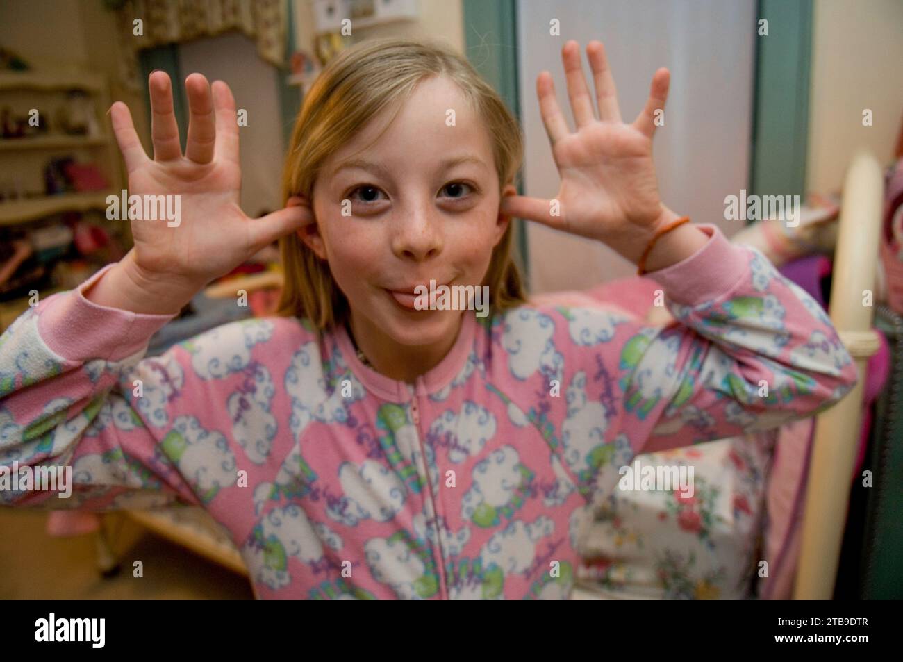 Girl in her bedroom getting ready for bed and making a silly face for ...