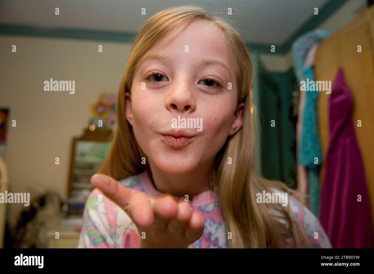 Girl in her bedroom getting ready for bed and blows a kiss to the ...