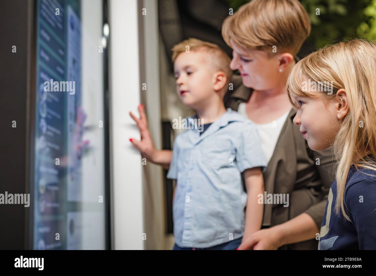 Family, cute blonde little boy and his toddler sister having fun with ...