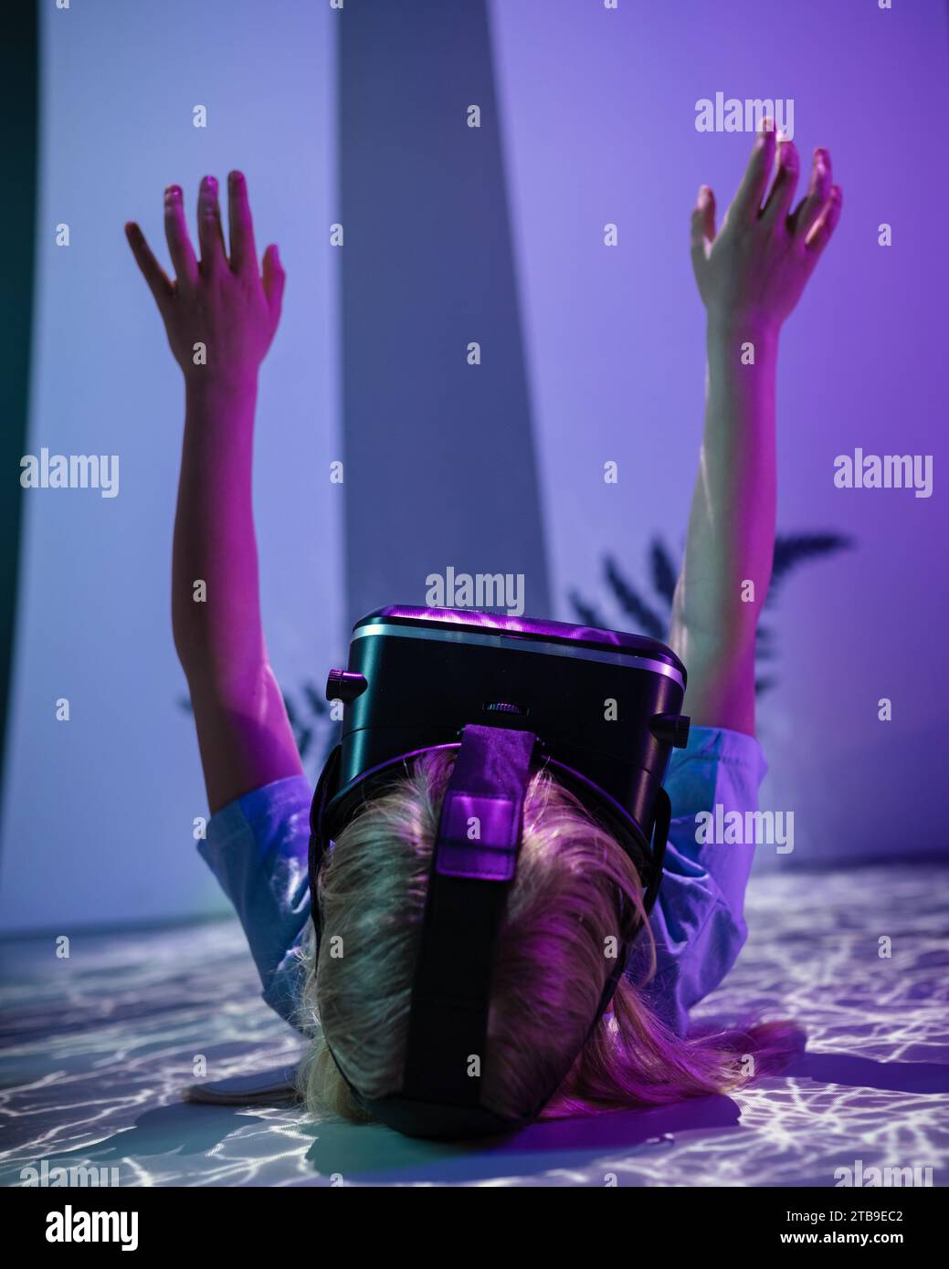 Little girl having a fantastic virtual reality experience, laying on ...