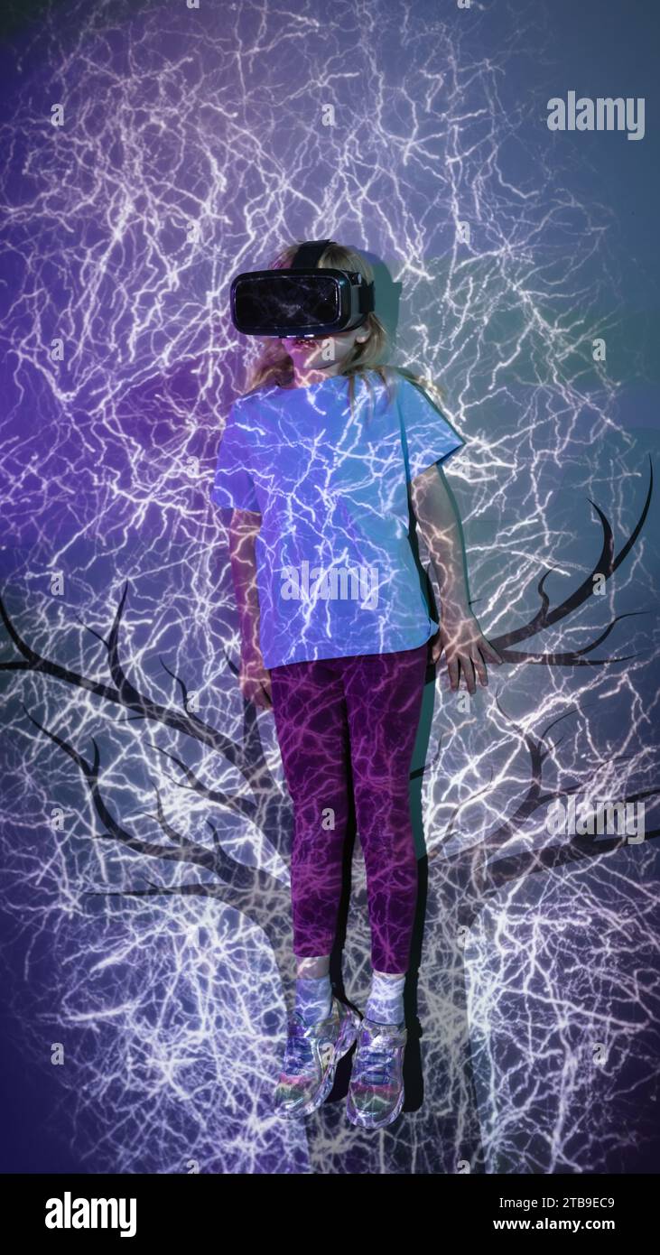 Little girl having a fantastic virtual reality experience, laying on ...