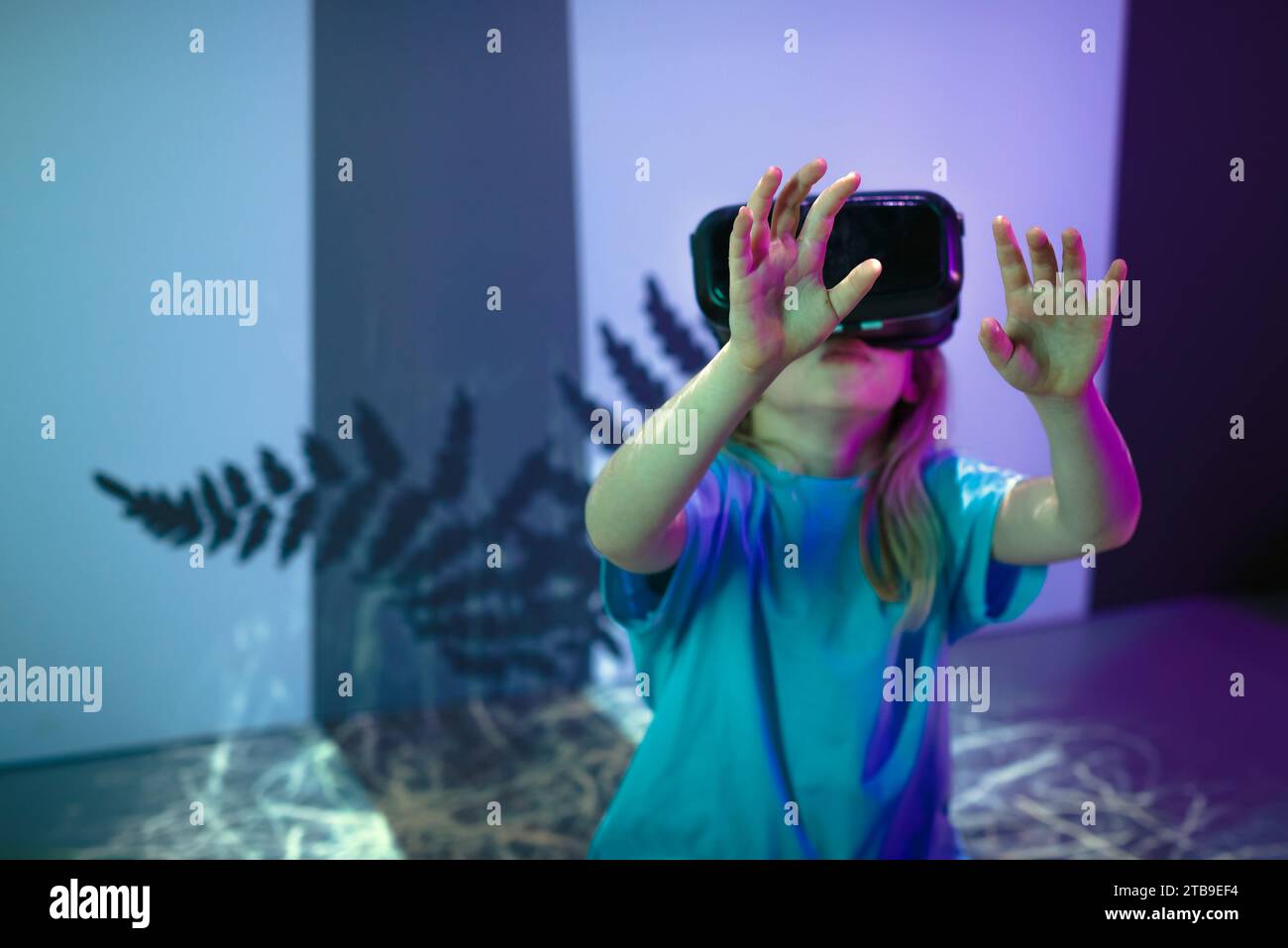 Female child using new technologies, having fun wearing virtual reality ...