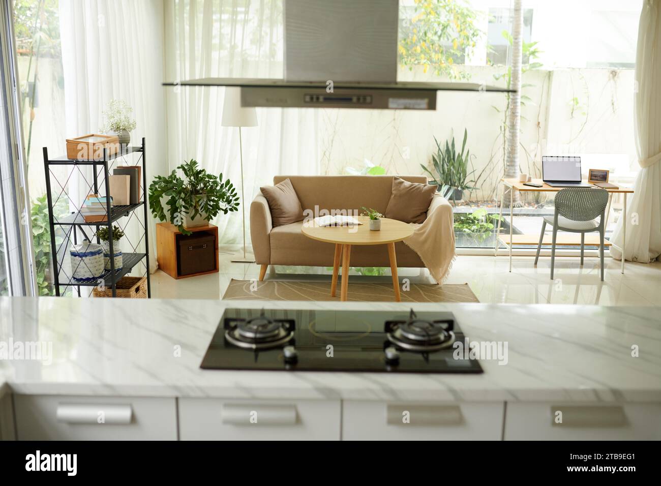 Comfy couch and small coffee table in living room, view from kitchen ...