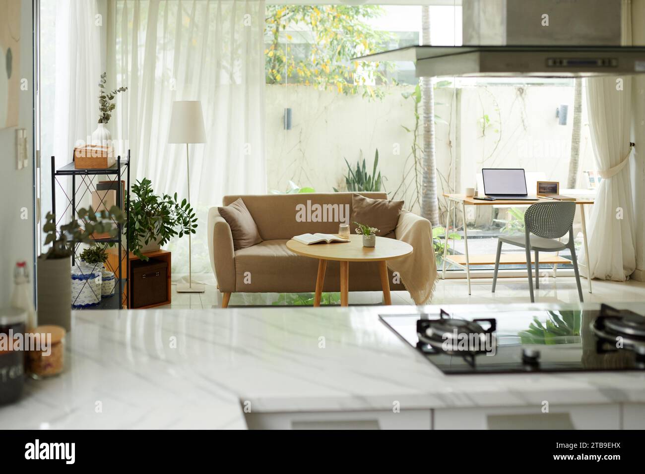 Modern living room area with big windows home design Stock Photo - Alamy