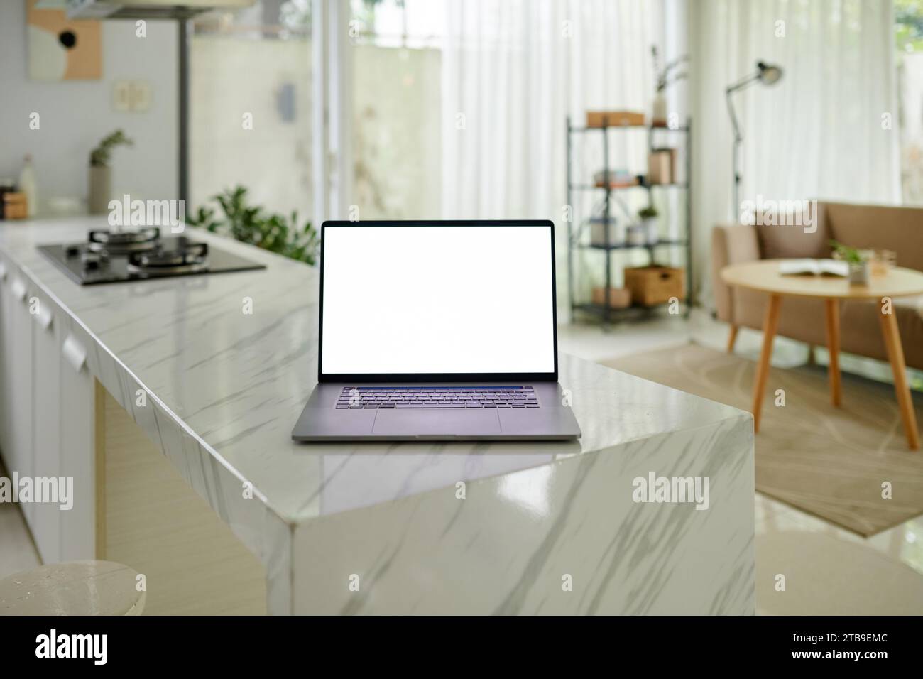 Laptop with empty screen on kitchen counter Stock Photo - Alamy