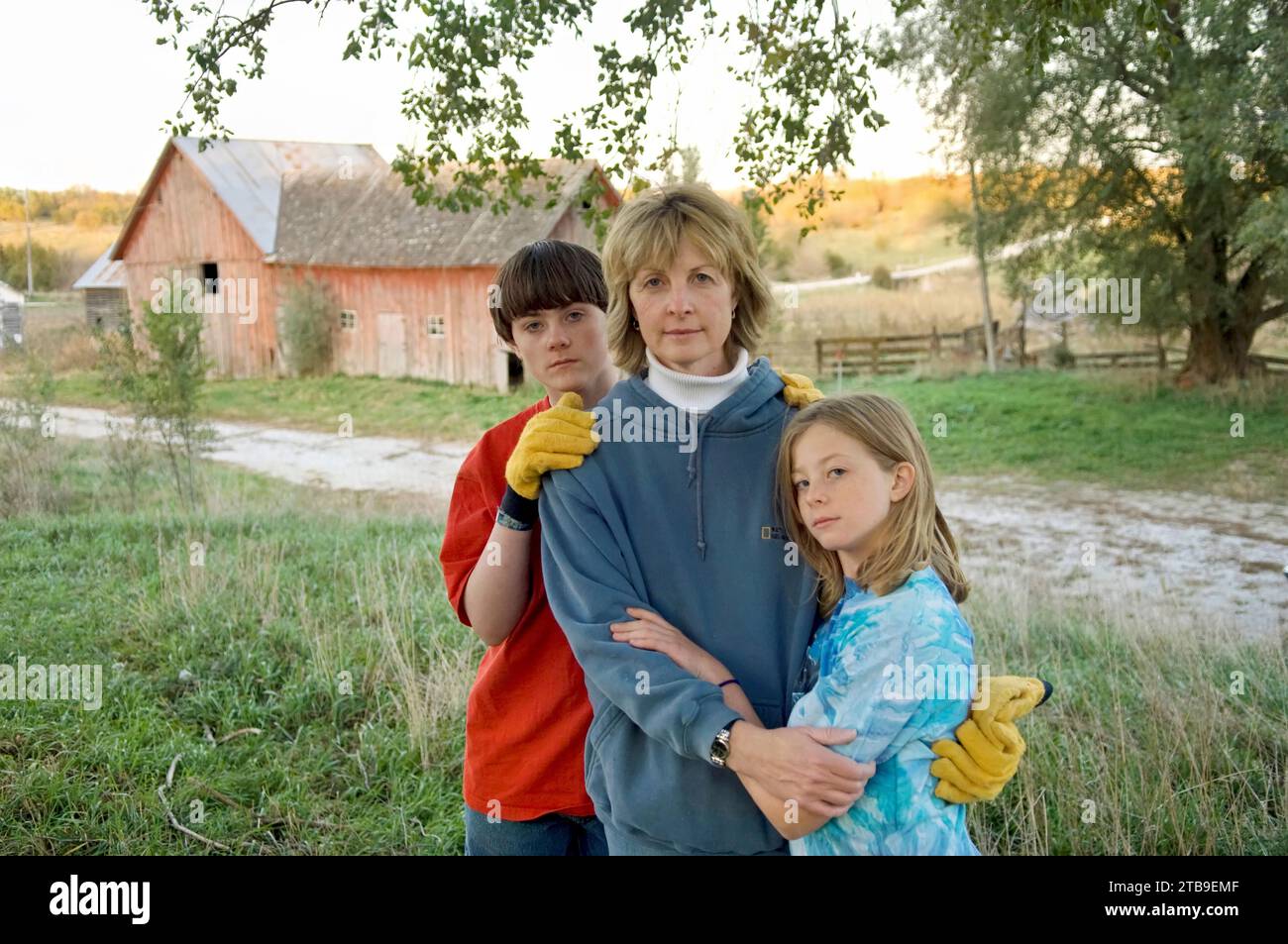Portrait of a mother and her two children posing on a farm; Dunbar ...