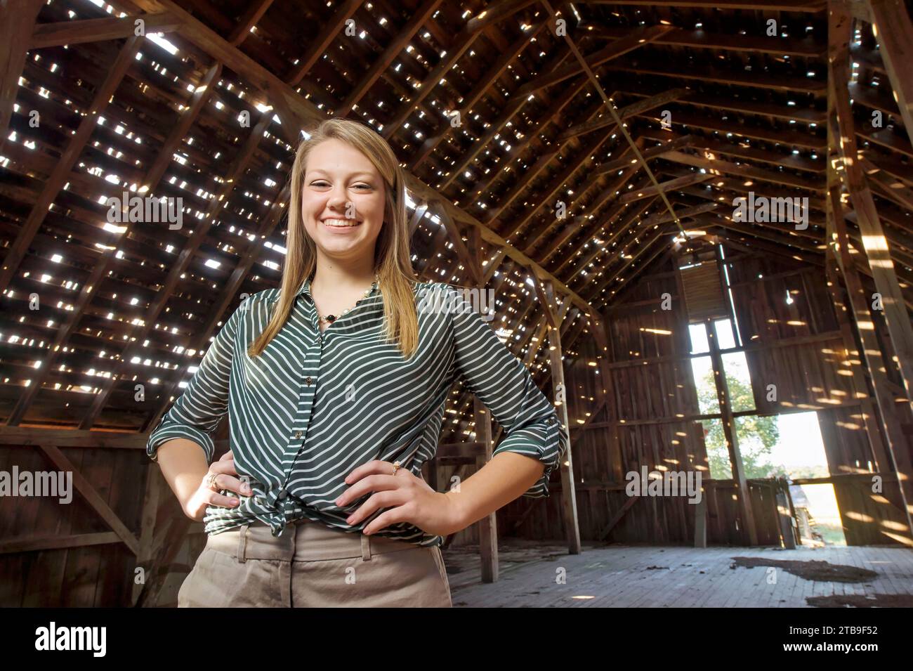 Portrait of a teenage girl in an old barn; Dunbar, Nebraska, United ...