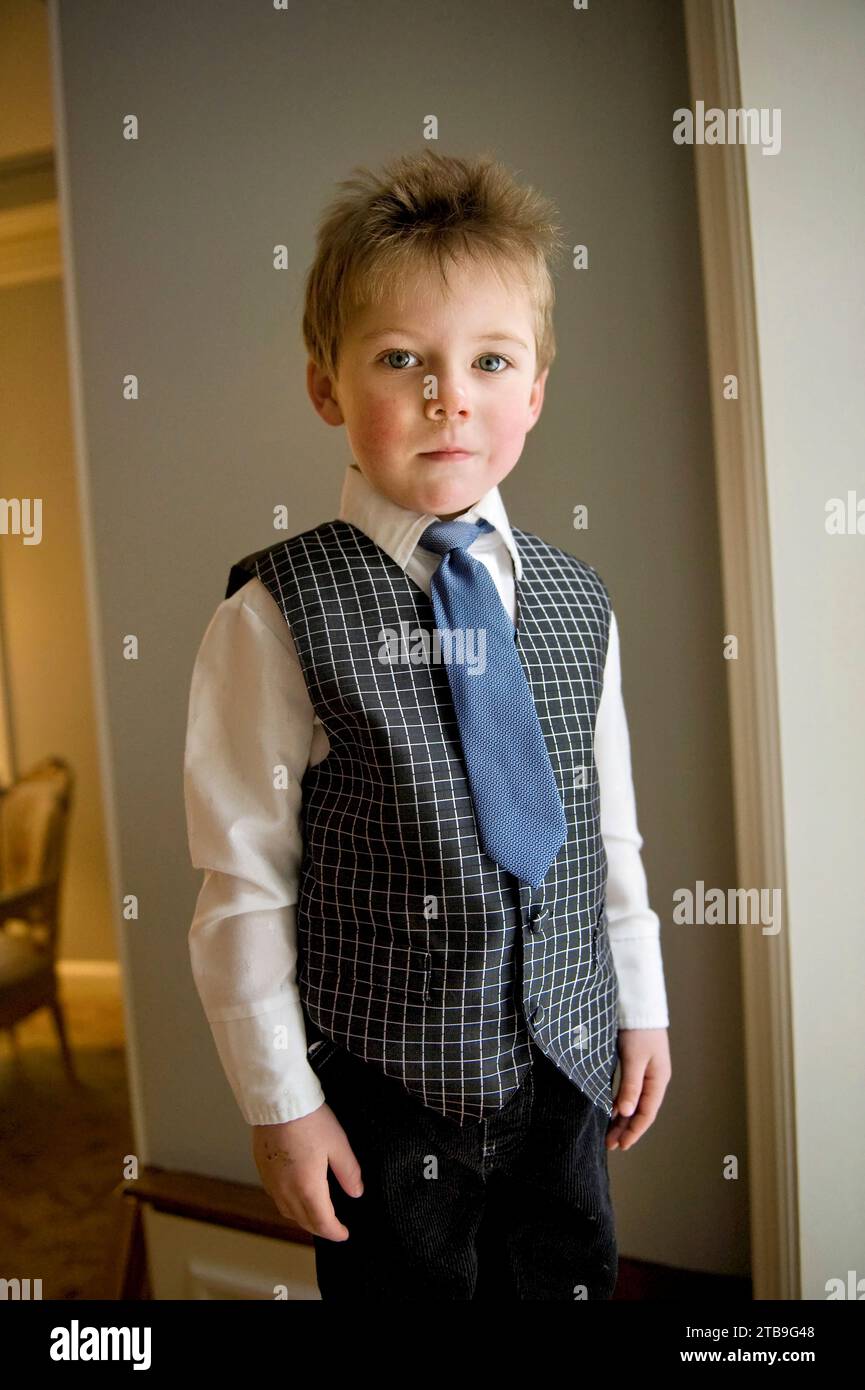 Young boy in formal wear poses for a photograph; Lincoln, Nebraska ...
