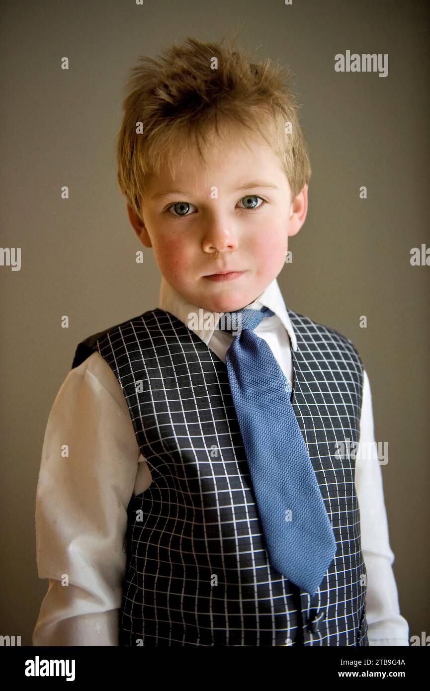 Young boy in formal wear poses for a photograph; Lincoln, Nebraska ...
