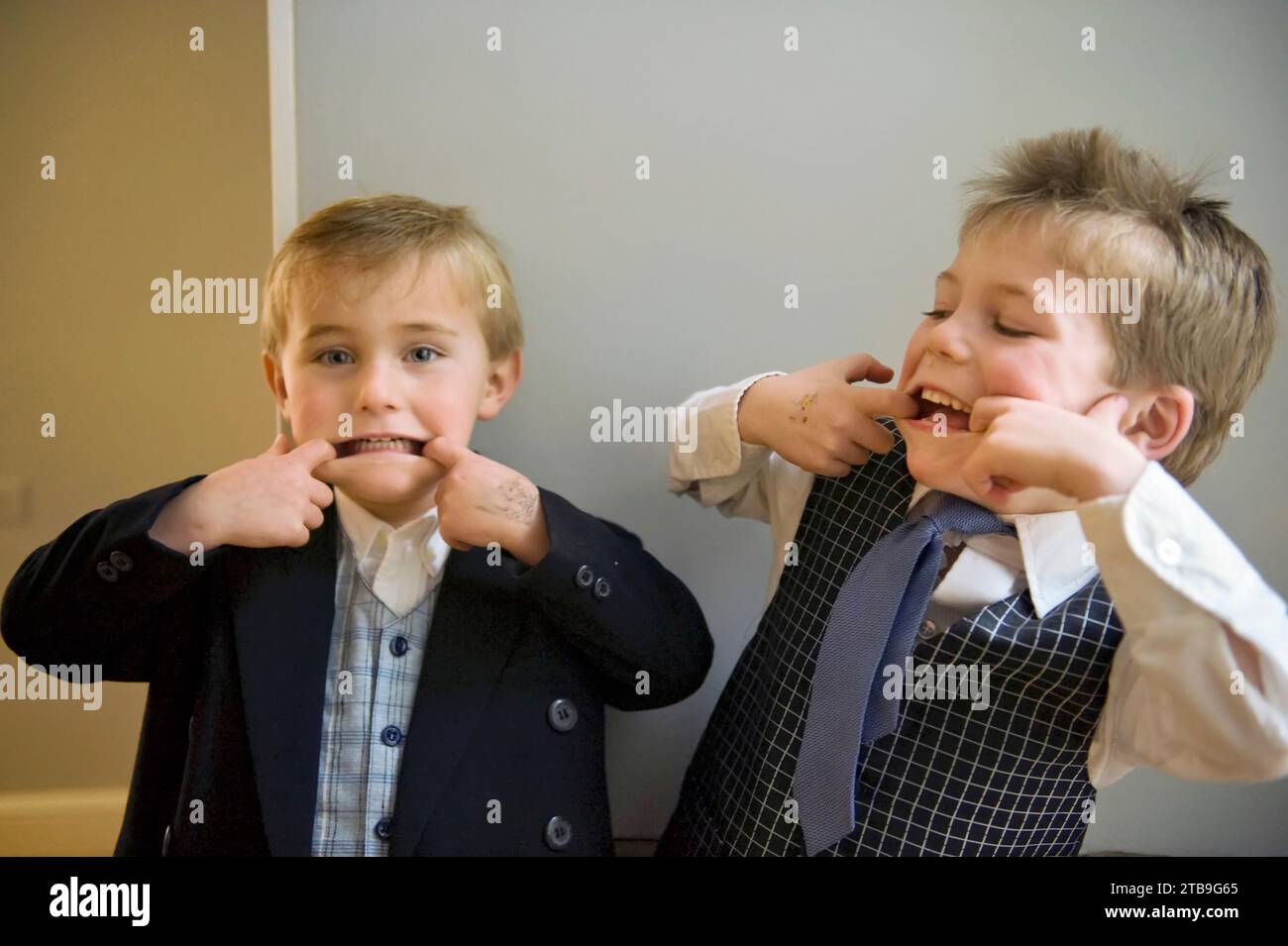 Two young brothers in suits make silly faces; Lincoln, Nebraska, United ...