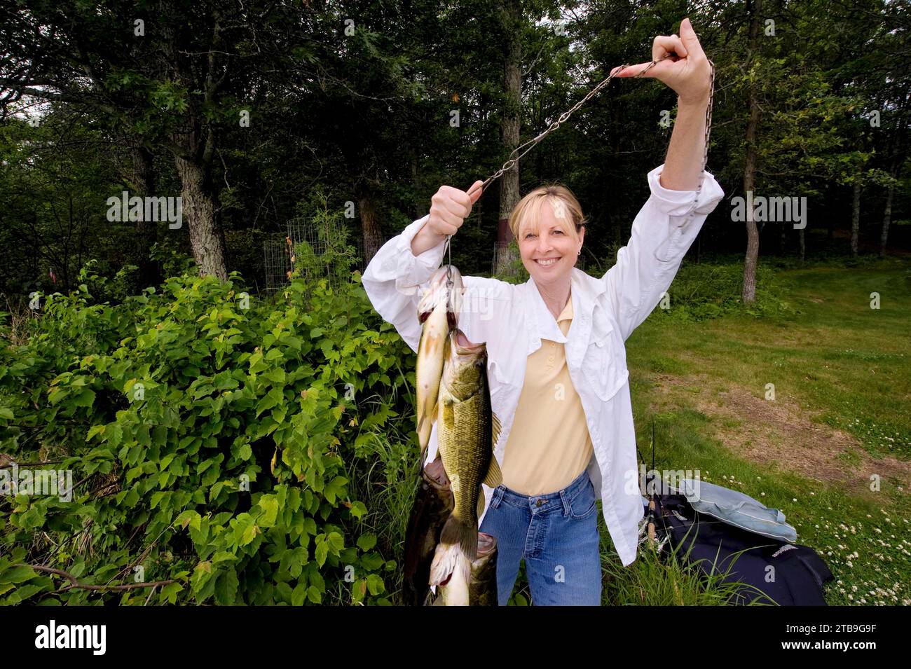 Woman displays several fish she caught in a lake; Crosslake, Minnesota ...