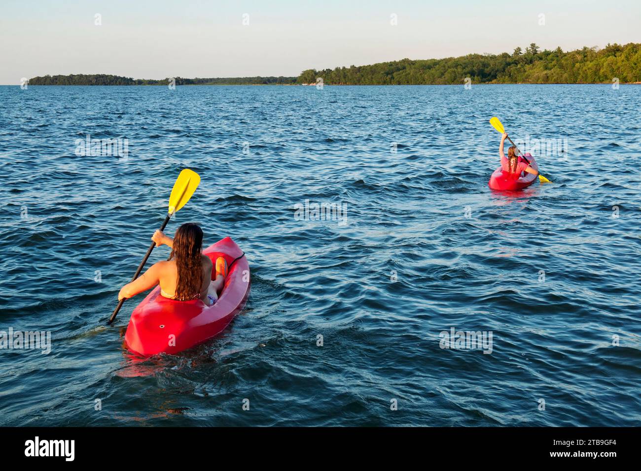 Teenage girl kayaking with a friend on Leech Lake in Minnesota, USA ...