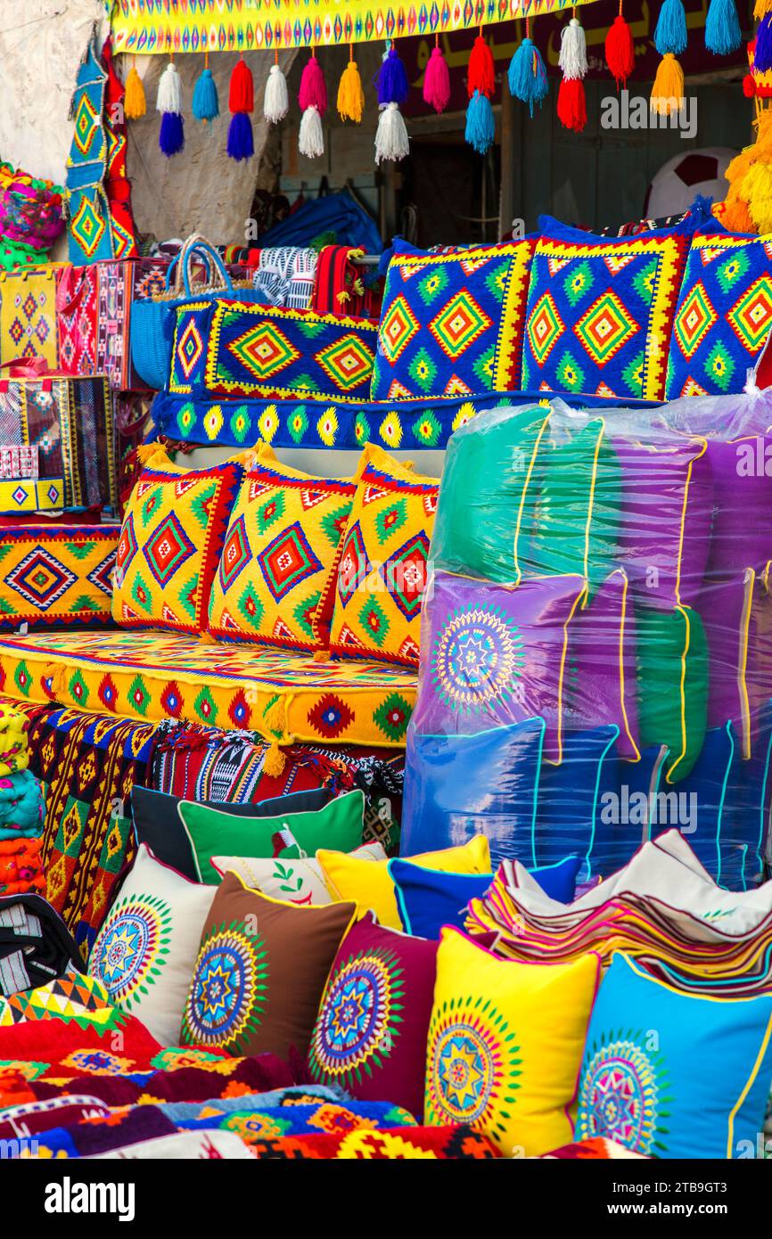 Colorful market stall selling pillows and cushions in traditional ...