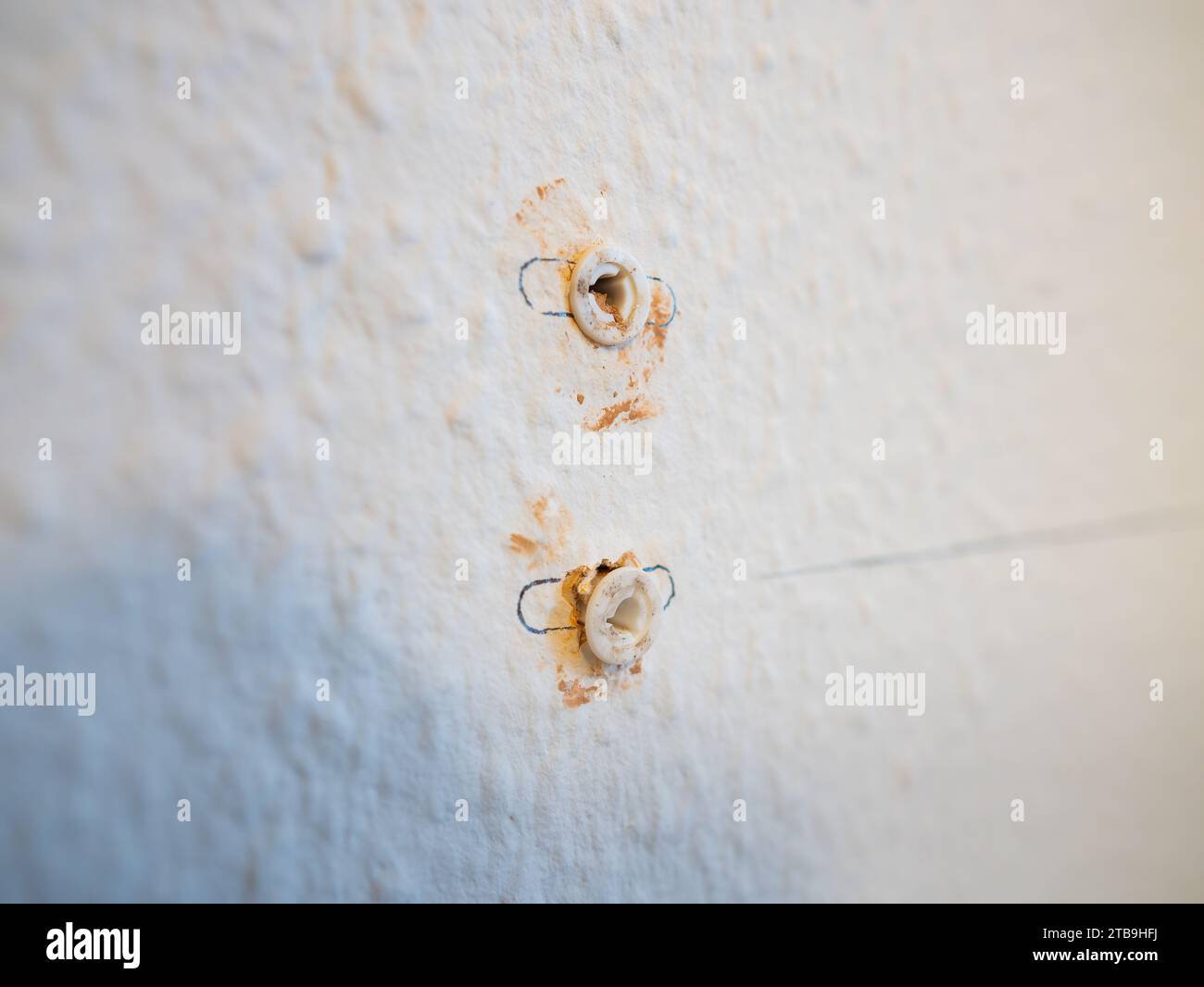Wall anchor installed in an apartment. Dust and dirt of the red brick ...