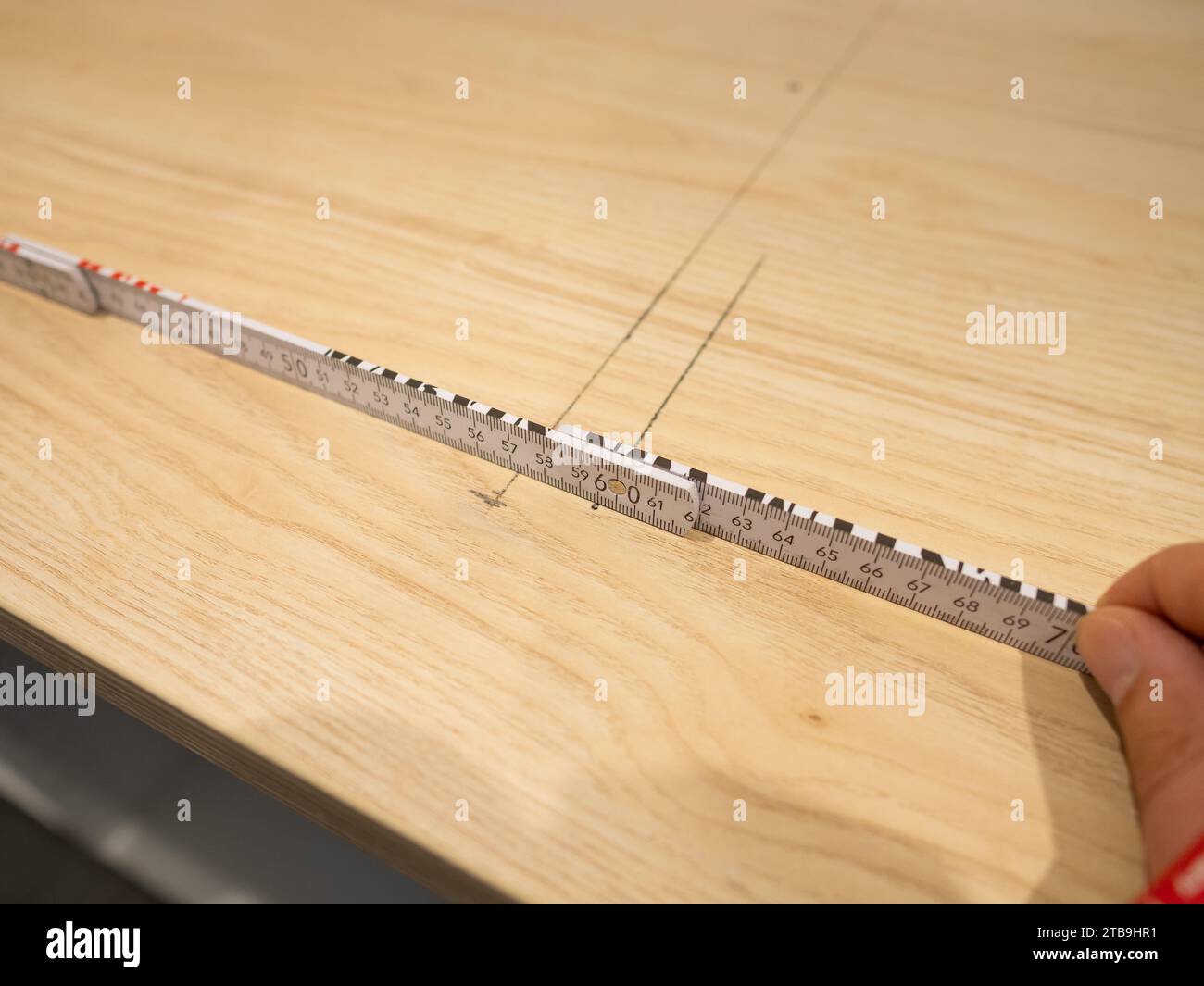 Measuring the position with a folding ruler. Markings on a wooden ...