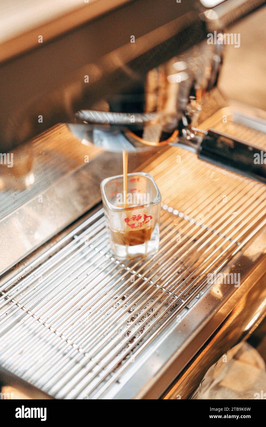 A modern coffee machine pulling an espresso shot Stock Photo - Alamy