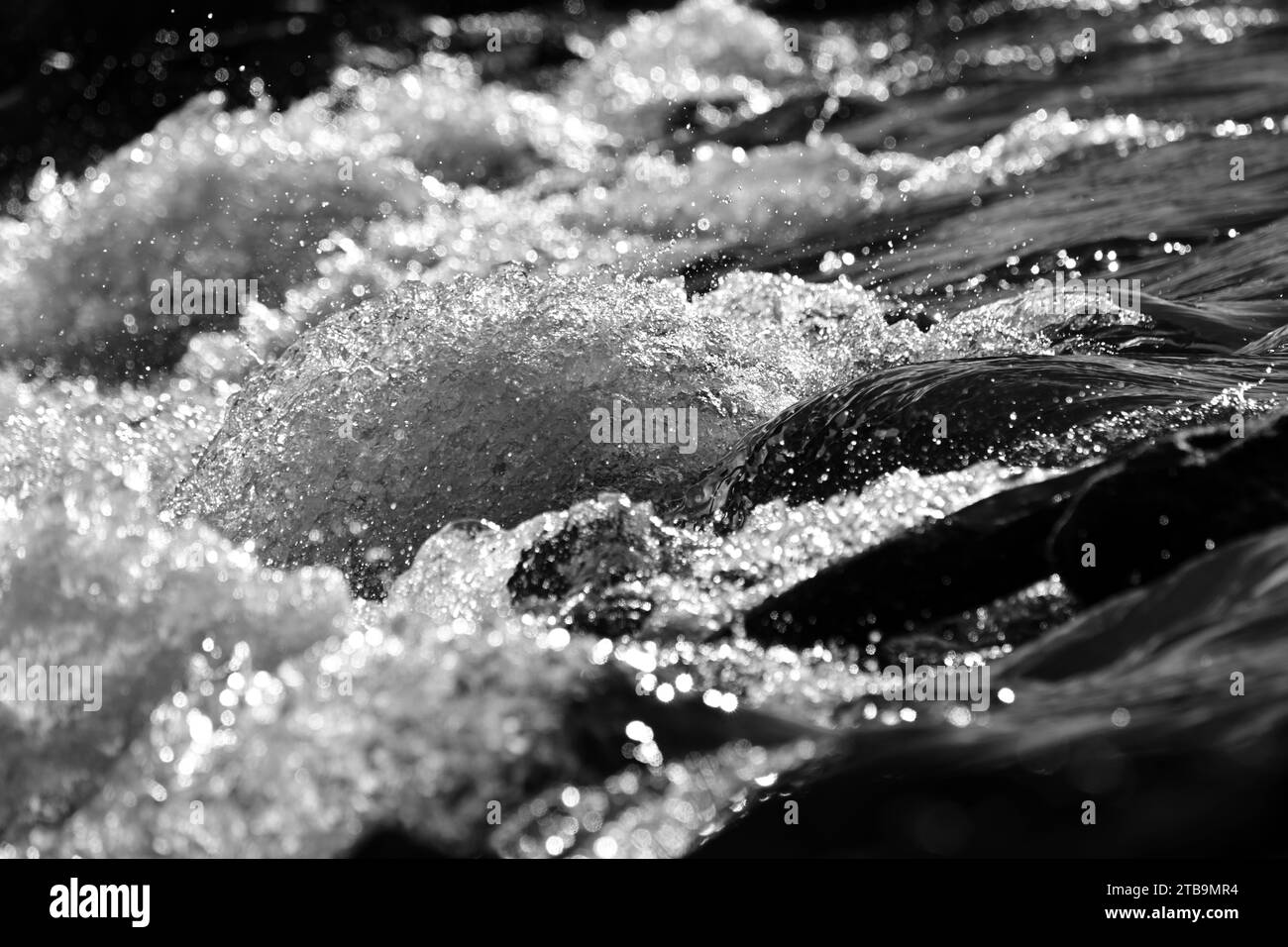 Dynamic capture of splashing water in motion near river Danube in black ...