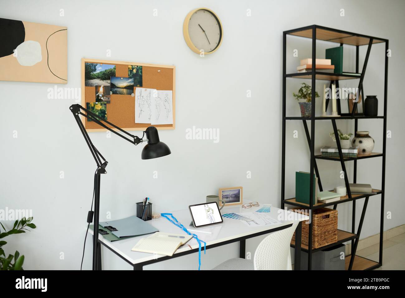 Workplace of fashion designer with desk, pinboard and shelves Stock ...