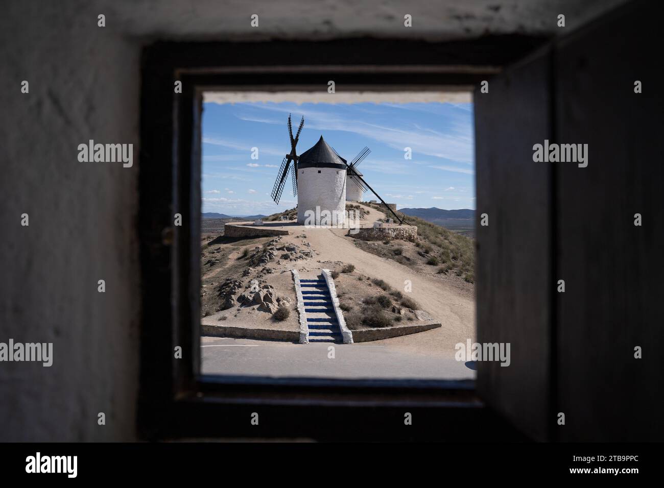 Old Spanish windmills seen from inside another windmill through a small ...