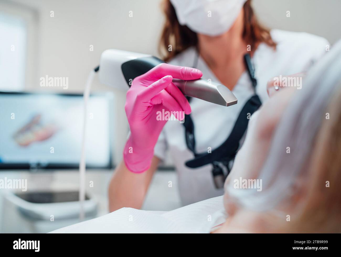 Dentist female doctor in uniform using intraoral 3D dental scanner ...