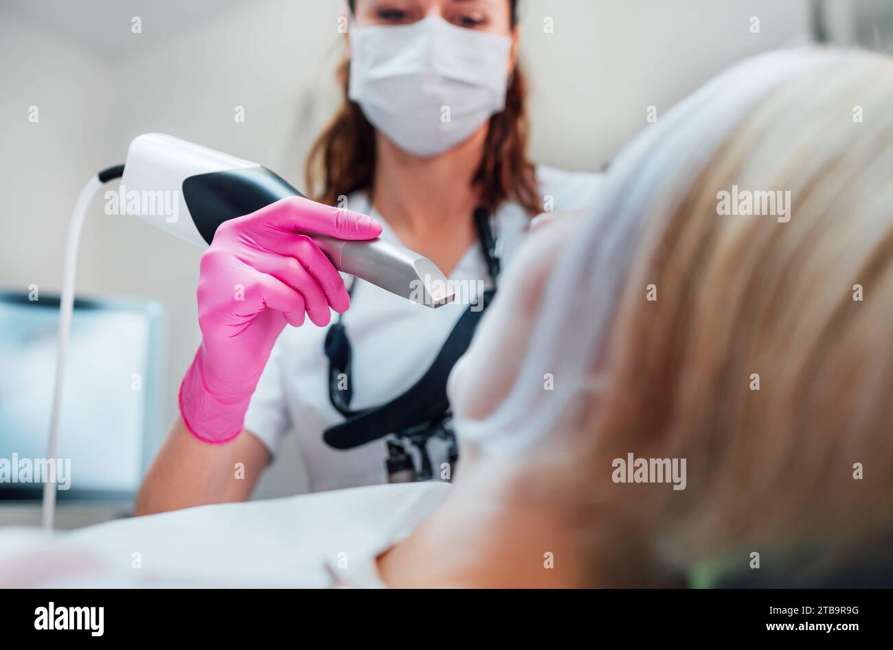 Dentist female doctor in uniform using intraoral 3D dental scanner ...