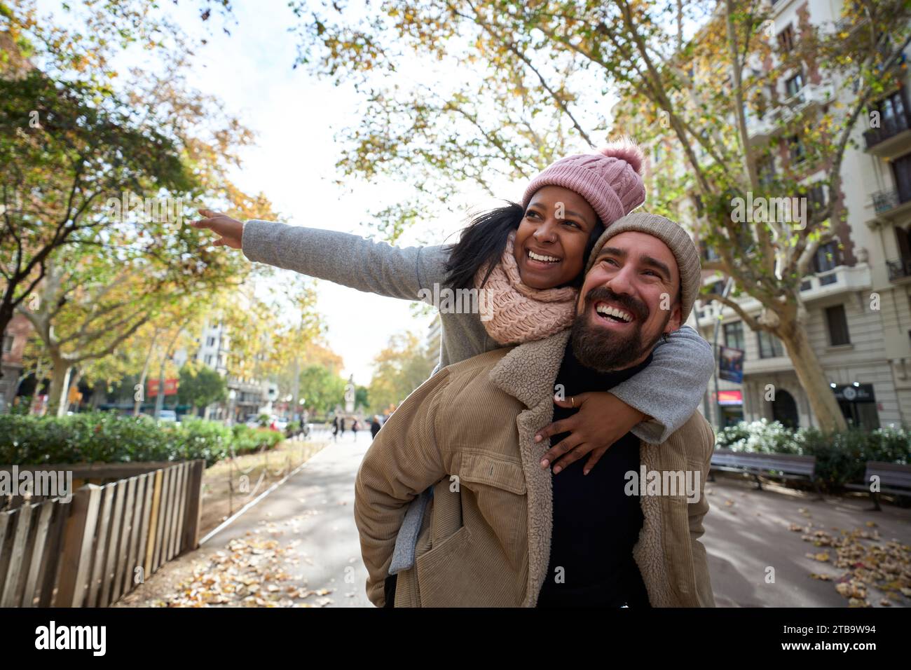 Portrait of young cheerful multiracial happy couple in love hugging and ...