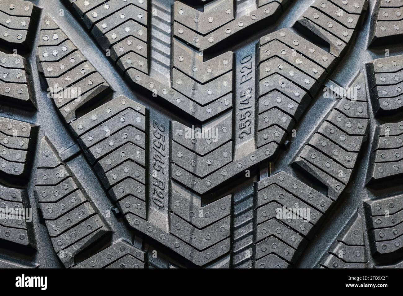 Tire tread with embossed tire size markings embedded in the tread ...