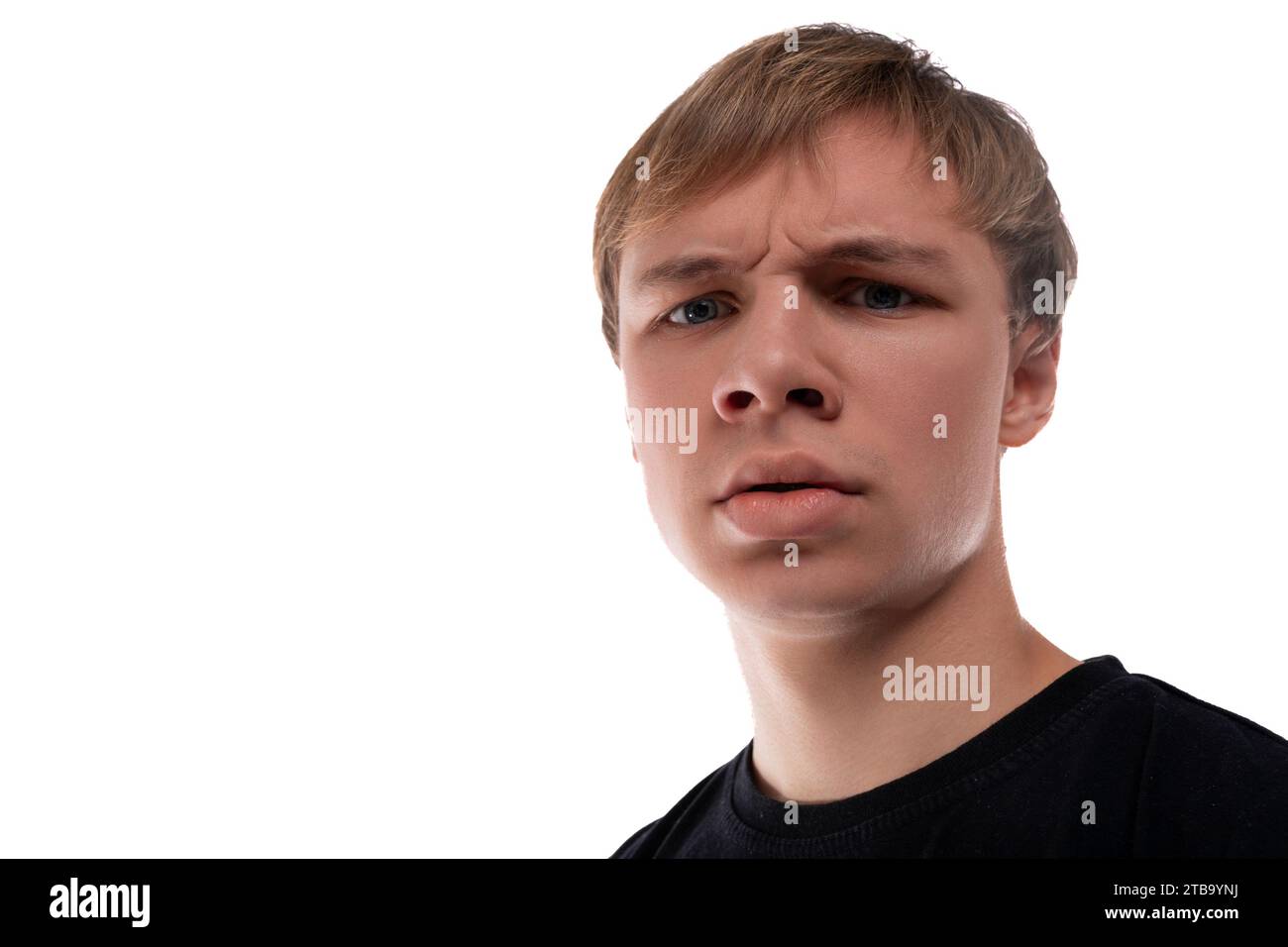 Close-up portrait of a blond 16 year old guy dressed in a black T-shirt ...