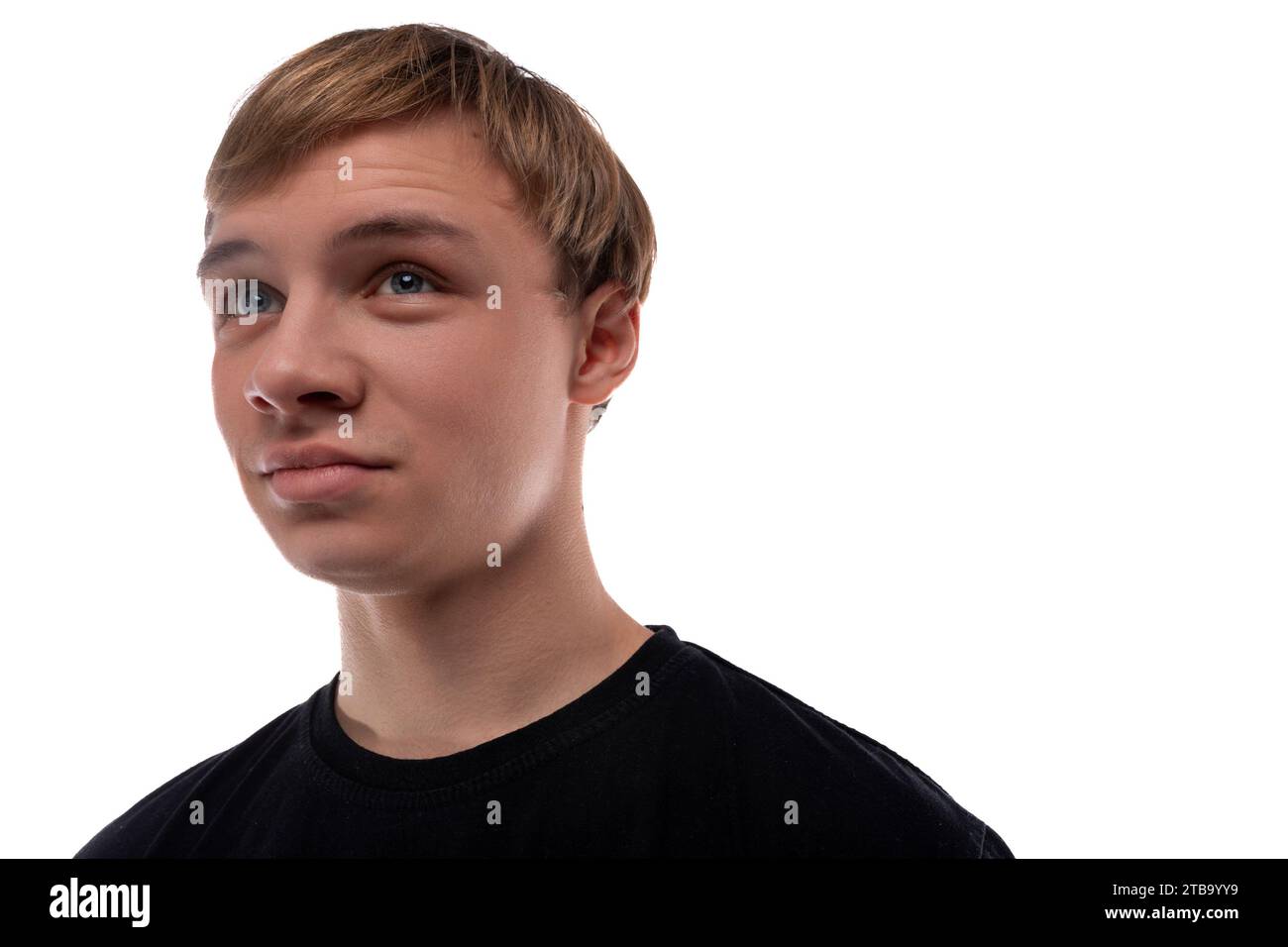 Close-up portrait of a blond 16 year old guy dressed in a black T-shirt ...