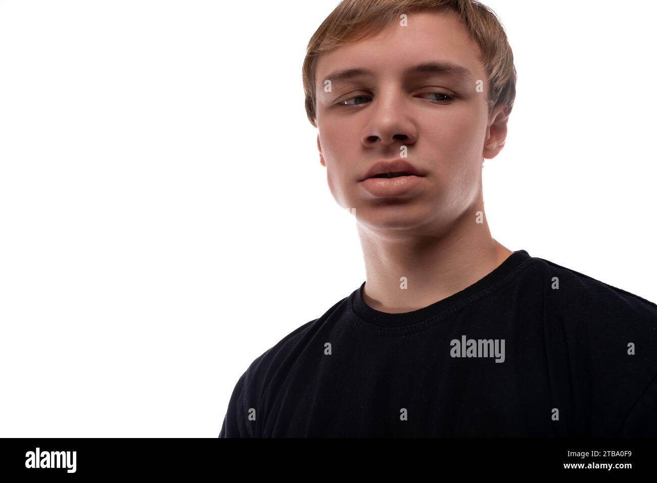 Cute fair-haired teenager guy on a white background, close-up portrait ...