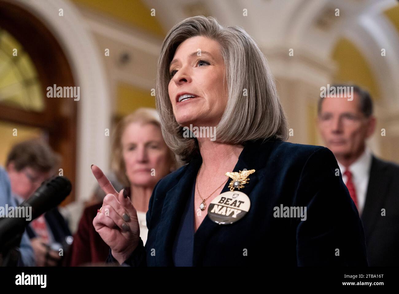 Sen. Joni Ernst, R-Iowa, wears a "Beat Navy" pin during a press ...