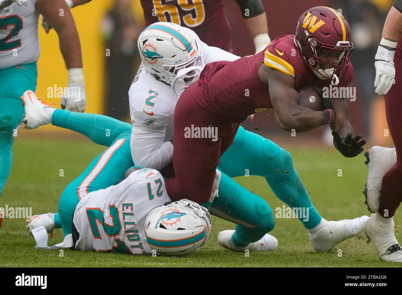 Washington Commanders running back Brian Robinson Jr. (8) is tackled by ...