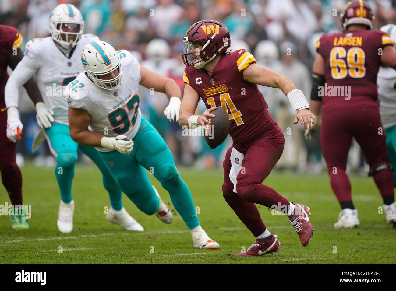 Washington Commanders quarterback Sam Howell (14) scrambles under ...