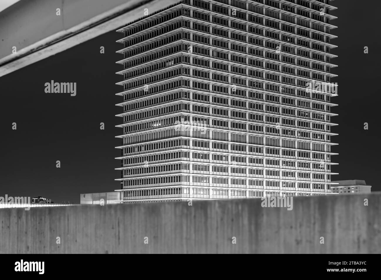 night time photo of a large concrete building from a downtown parking ...