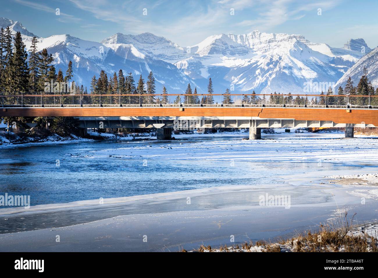 Pedestrian bridge crosses the Bow River overlooking the Canadian Rocky ...