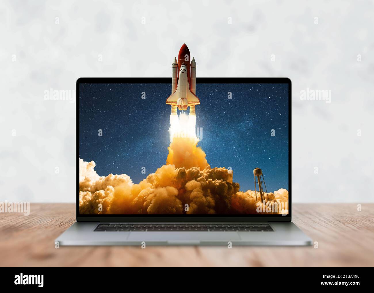 Laptop on the desktop and the space shuttle rocket successfully takes ...
