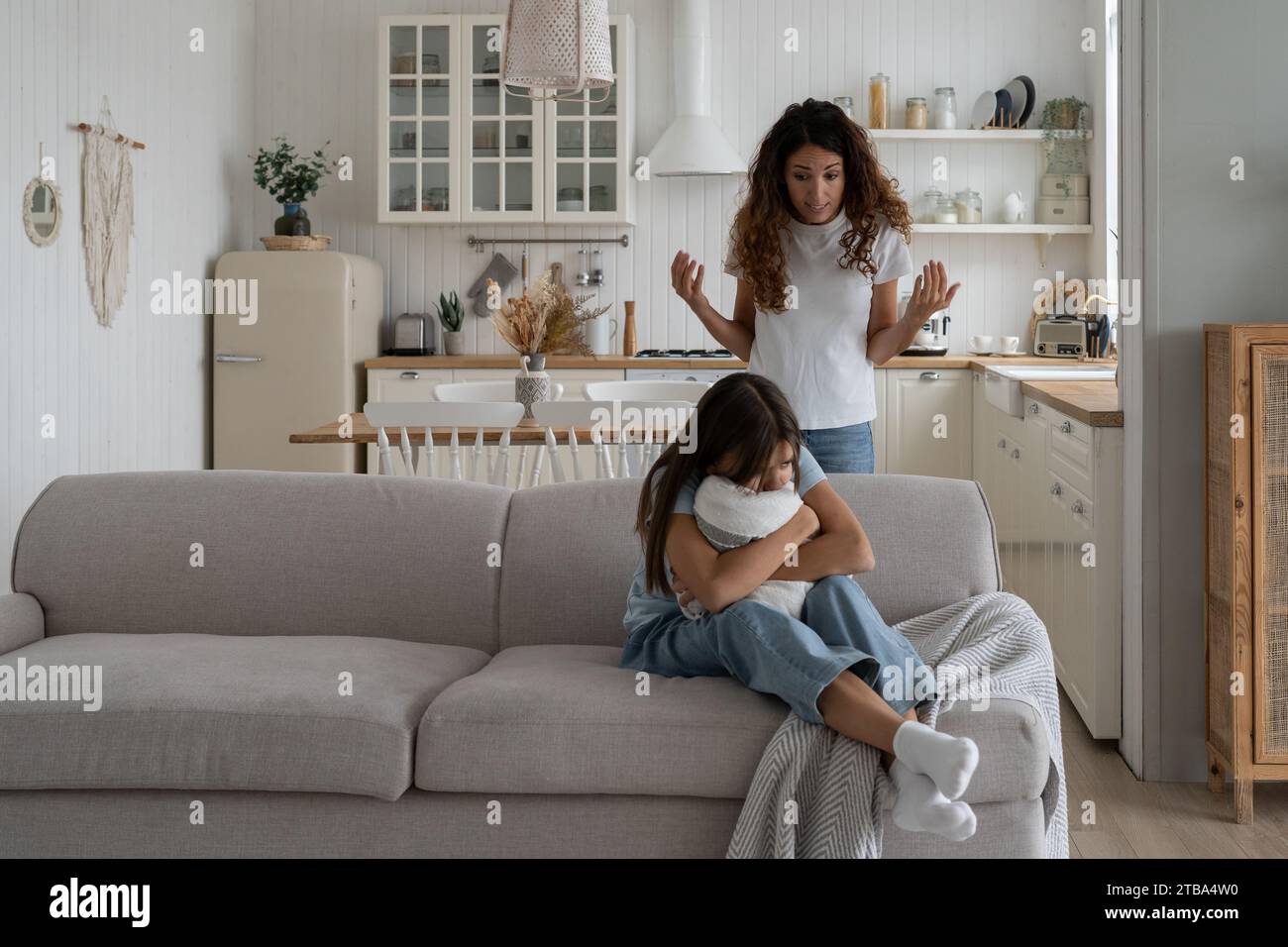 Angry woman mother blaming scolding sad girl daughter at home, dealing with child behavior ...
