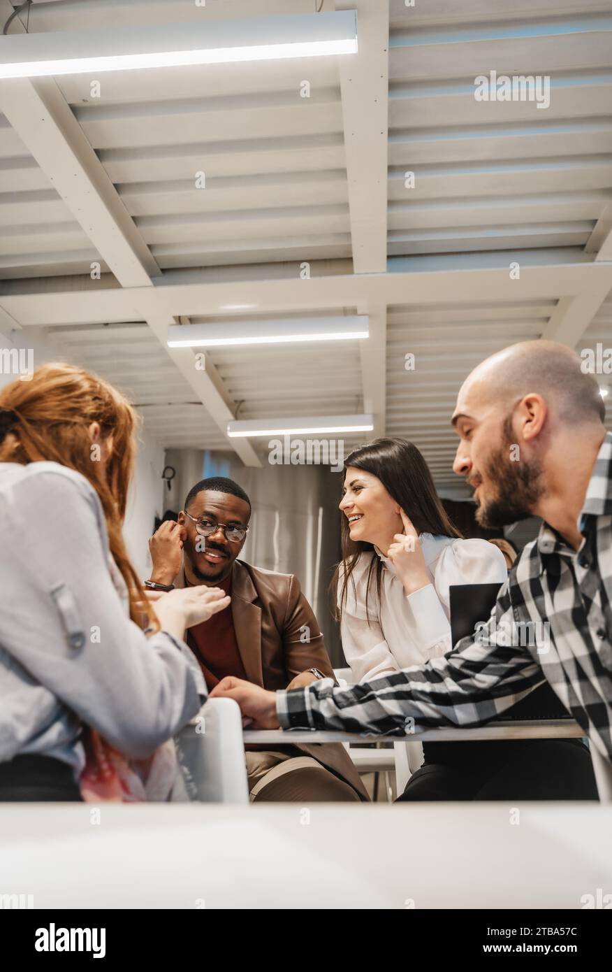 Young, female, ginger junior employee giving new ideas about the next ...