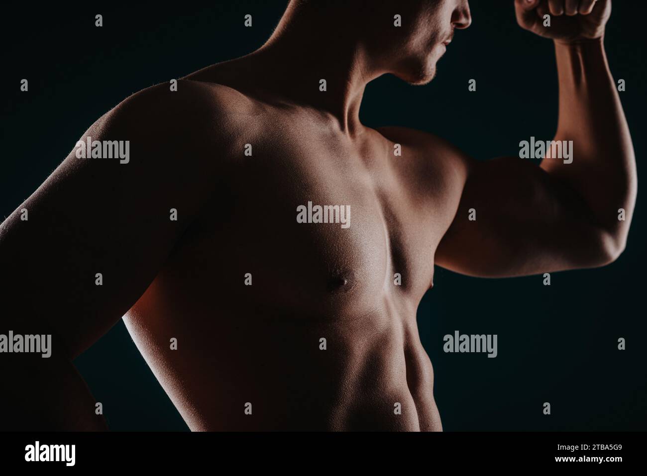Good-looking and muscular man flexing his bicep Stock Photo - Alamy
