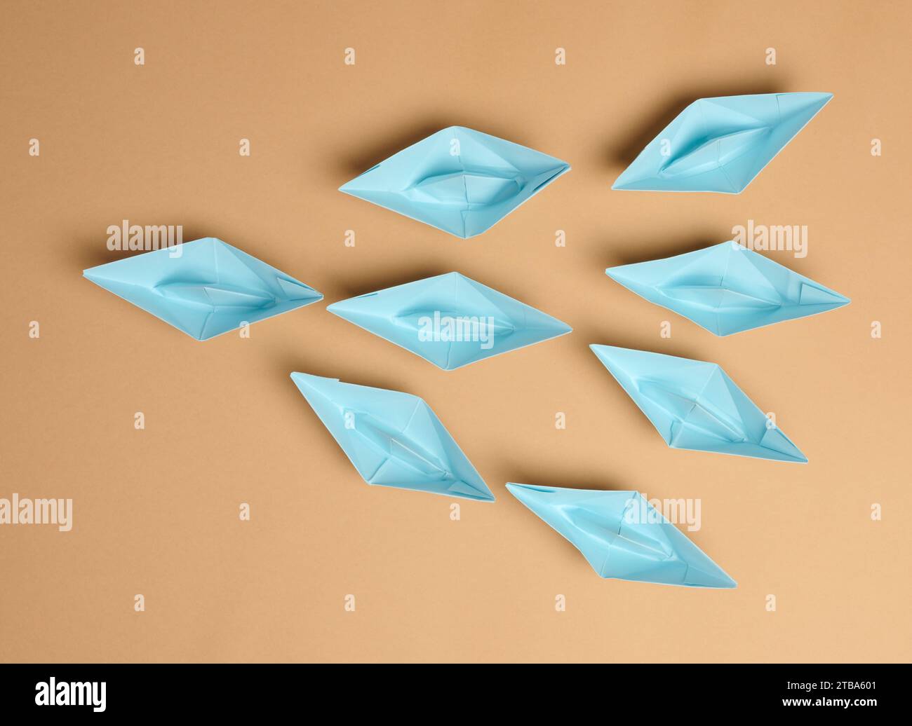 Group of paper boats on a brown background.Concept of a strong leader ...