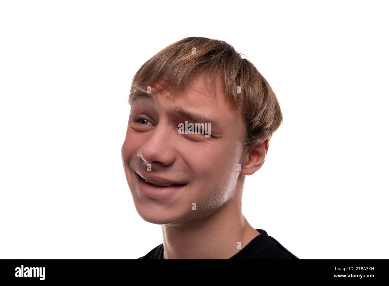 Satisfied European teenage guy with brown hair on a white background ...
